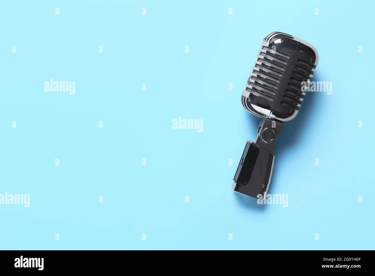 Retro microphone on color background Stock Photo - Alamy