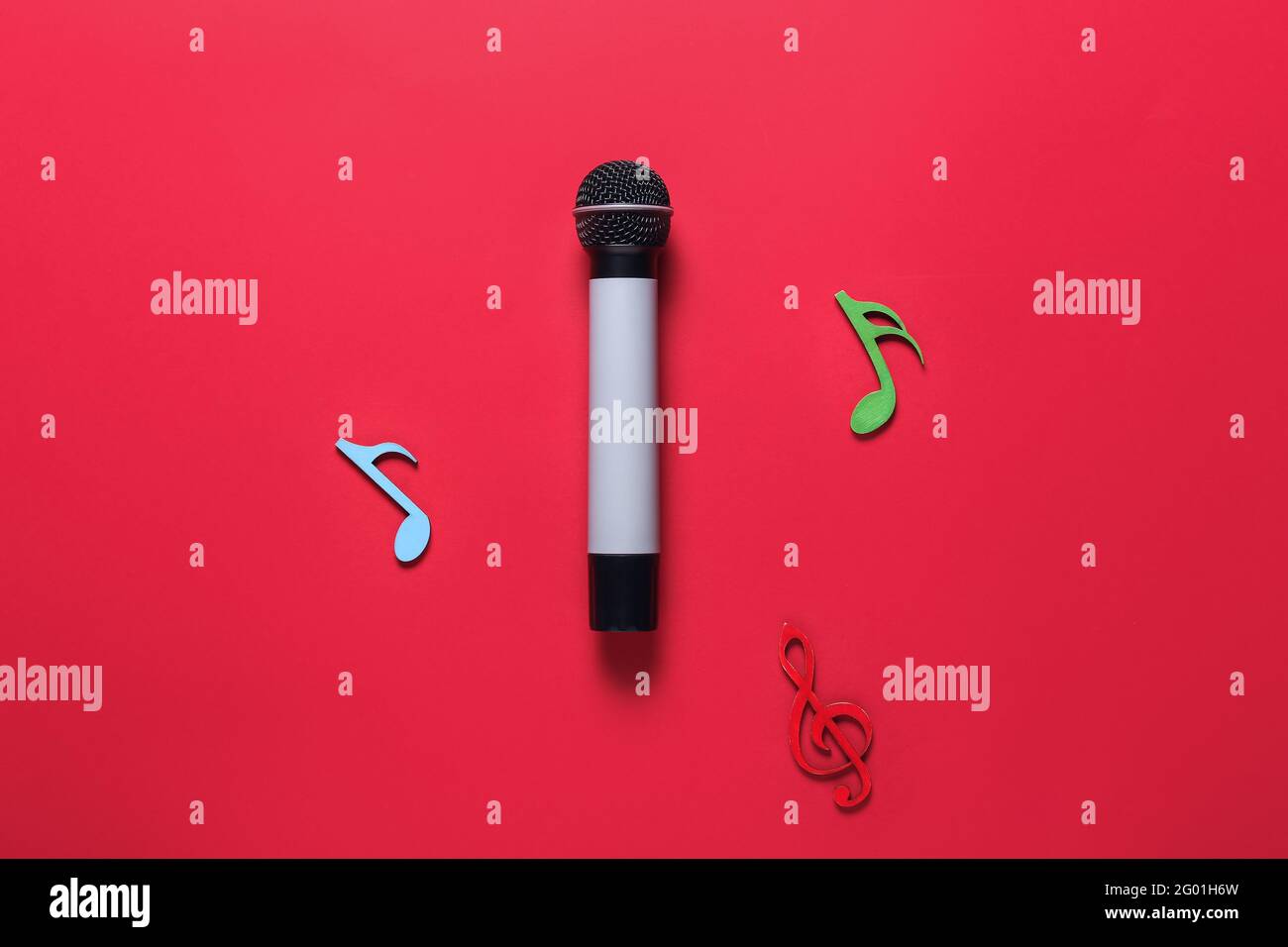 Modern microphone with music notes on color background Stock Photo - Alamy