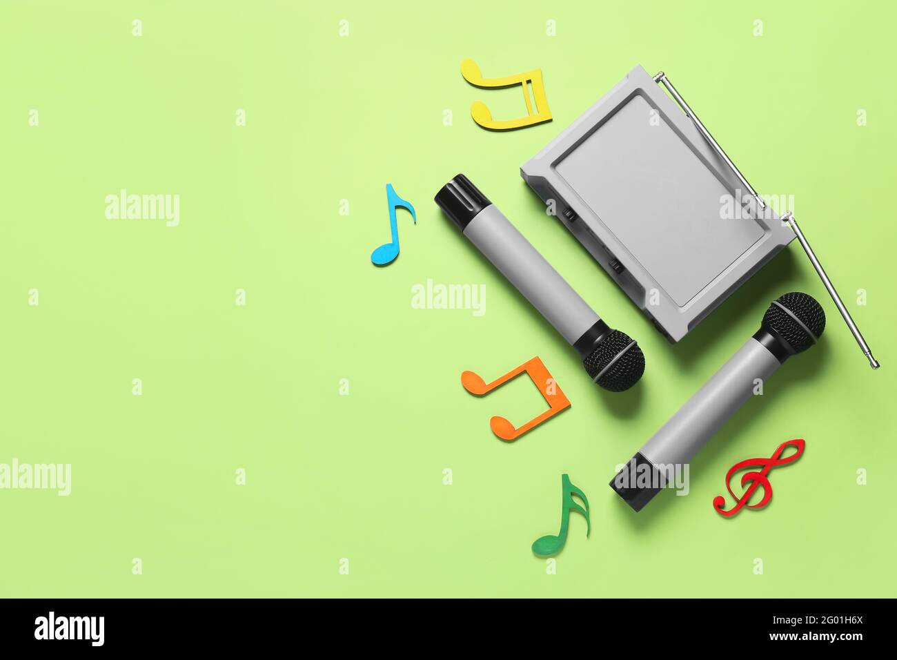 Modern microphones with audio system and music notes on color ...