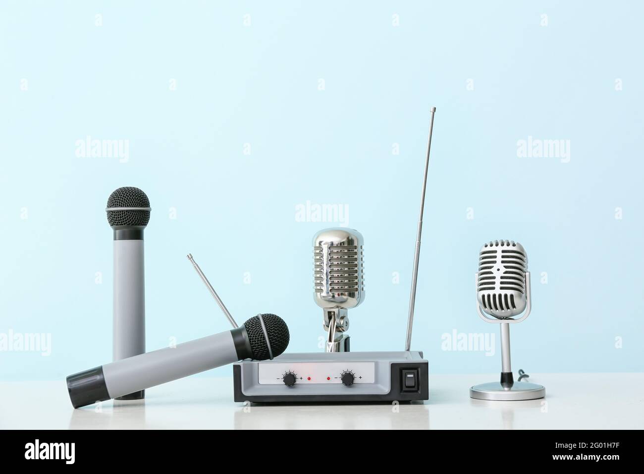 Different microphones and audio system on color background Stock Photo ...