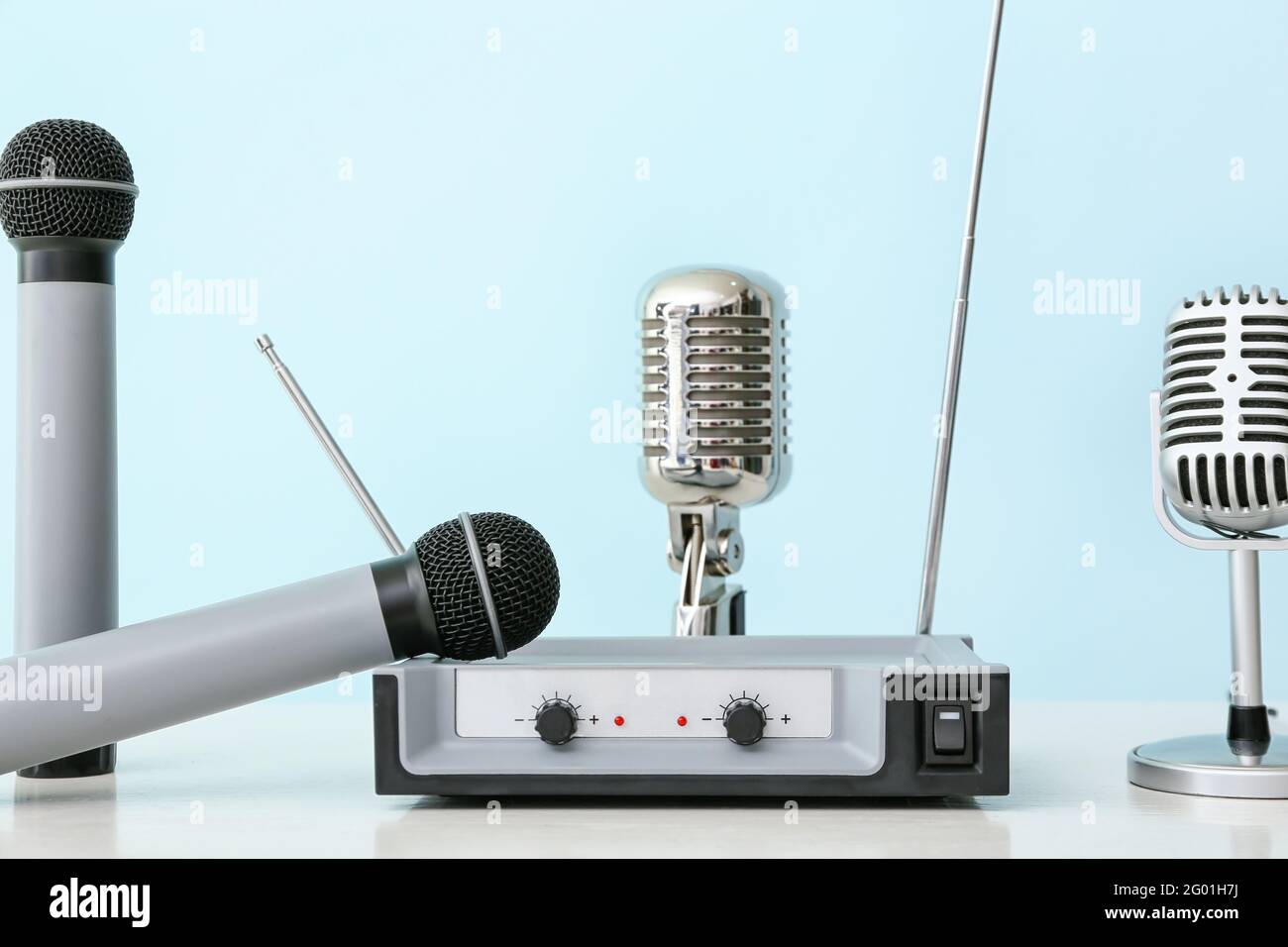 Different microphones and audio system on color background Stock Photo ...