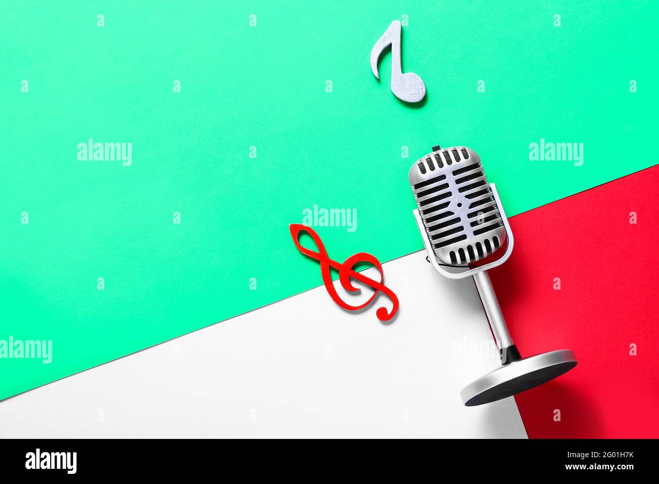 Retro microphone with music notes on color background Stock Photo - Alamy