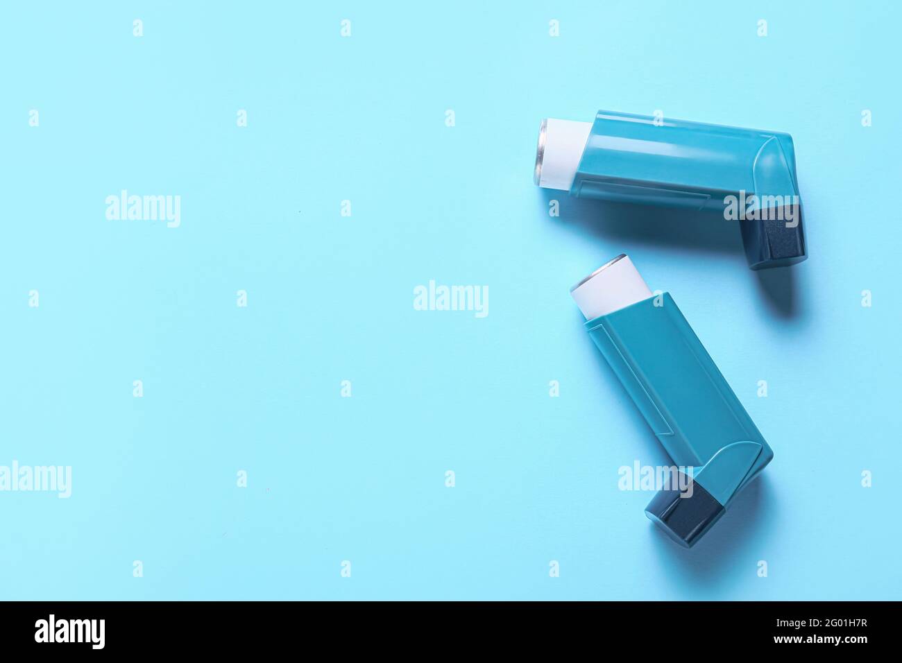 Modern inhalers on color background Stock Photo - Alamy