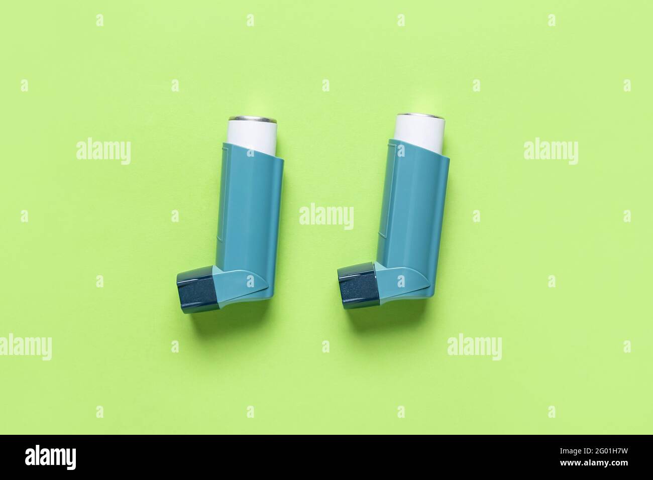 Modern inhalers on color background Stock Photo - Alamy