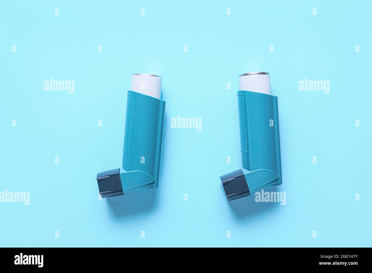 Modern inhalers on color background Stock Photo - Alamy