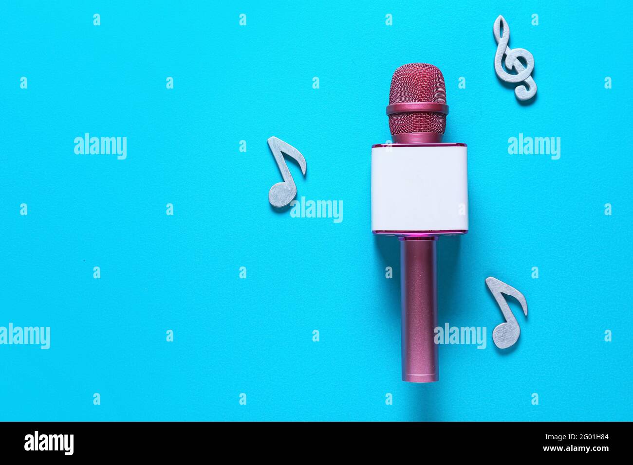 Modern microphone with music notes on color background Stock Photo - Alamy
