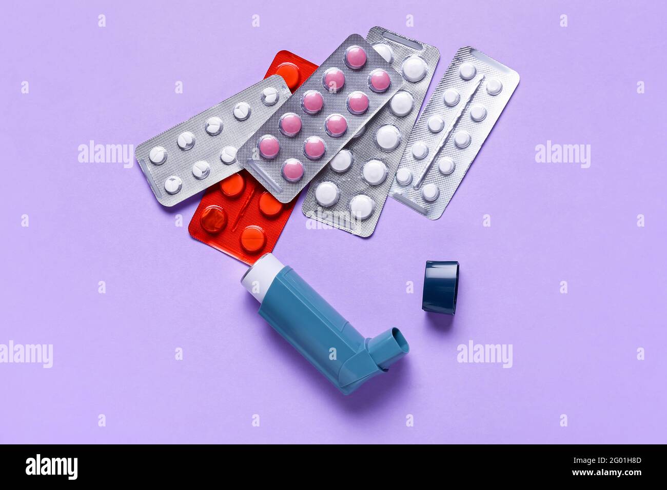 Inhaler with pills on color background Stock Photo - Alamy