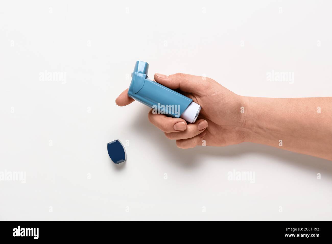 Female hand with inhaler on white background Stock Photo - Alamy