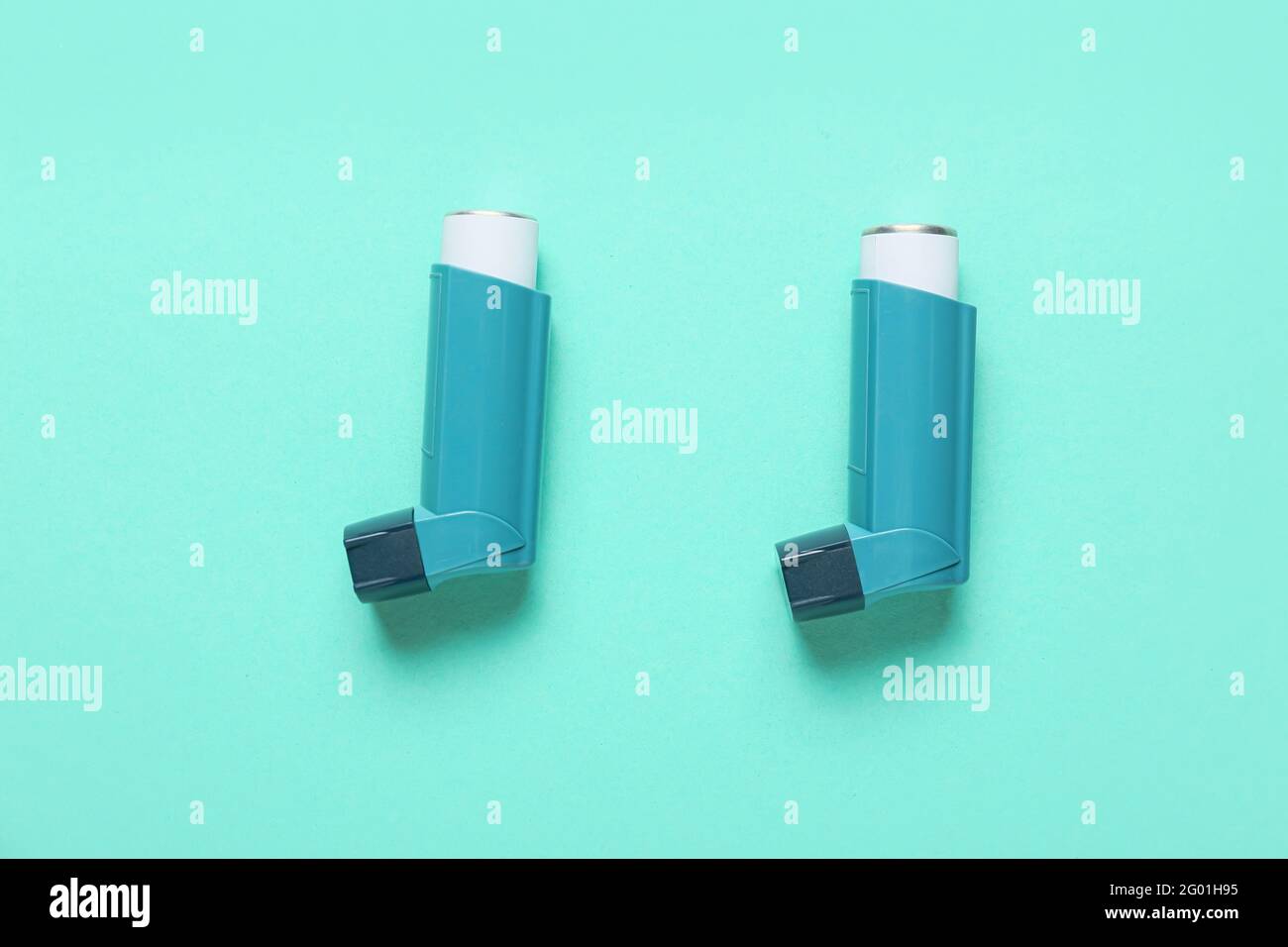 Modern inhalers on color background Stock Photo - Alamy