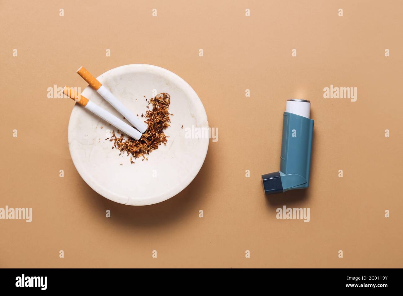 Inhaler and cigarettes on color background Stock Photo - Alamy