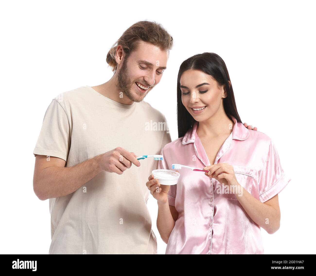 Young couple brushing teeth on white background Stock Photo - Alamy