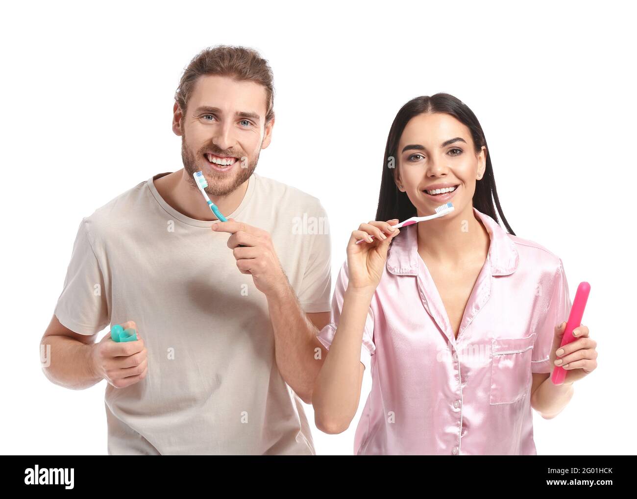 Young couple brushing teeth on white background Stock Photo - Alamy