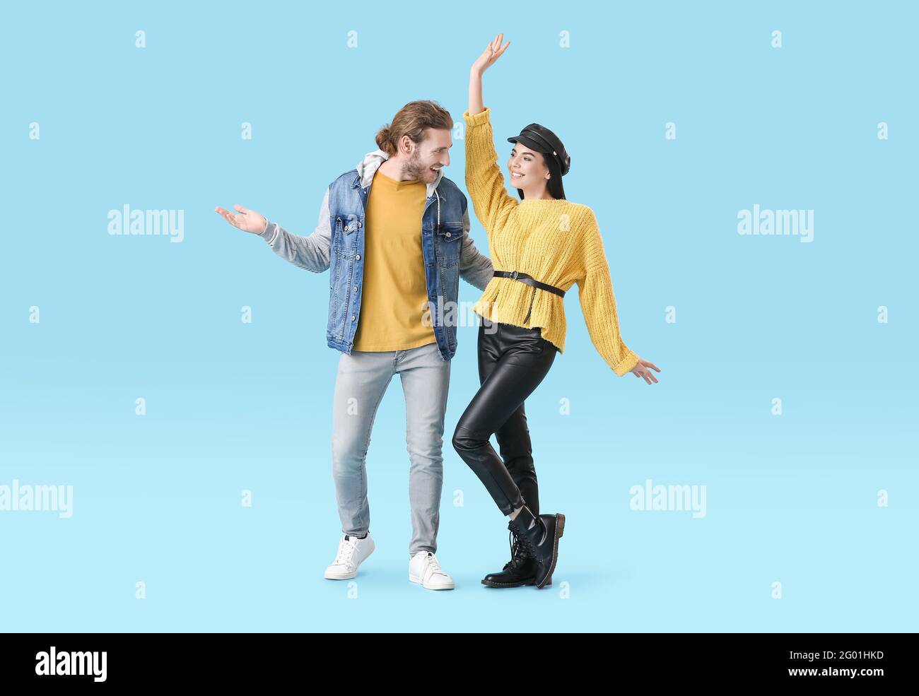 Happy young couple dancing on color background Stock Photo - Alamy