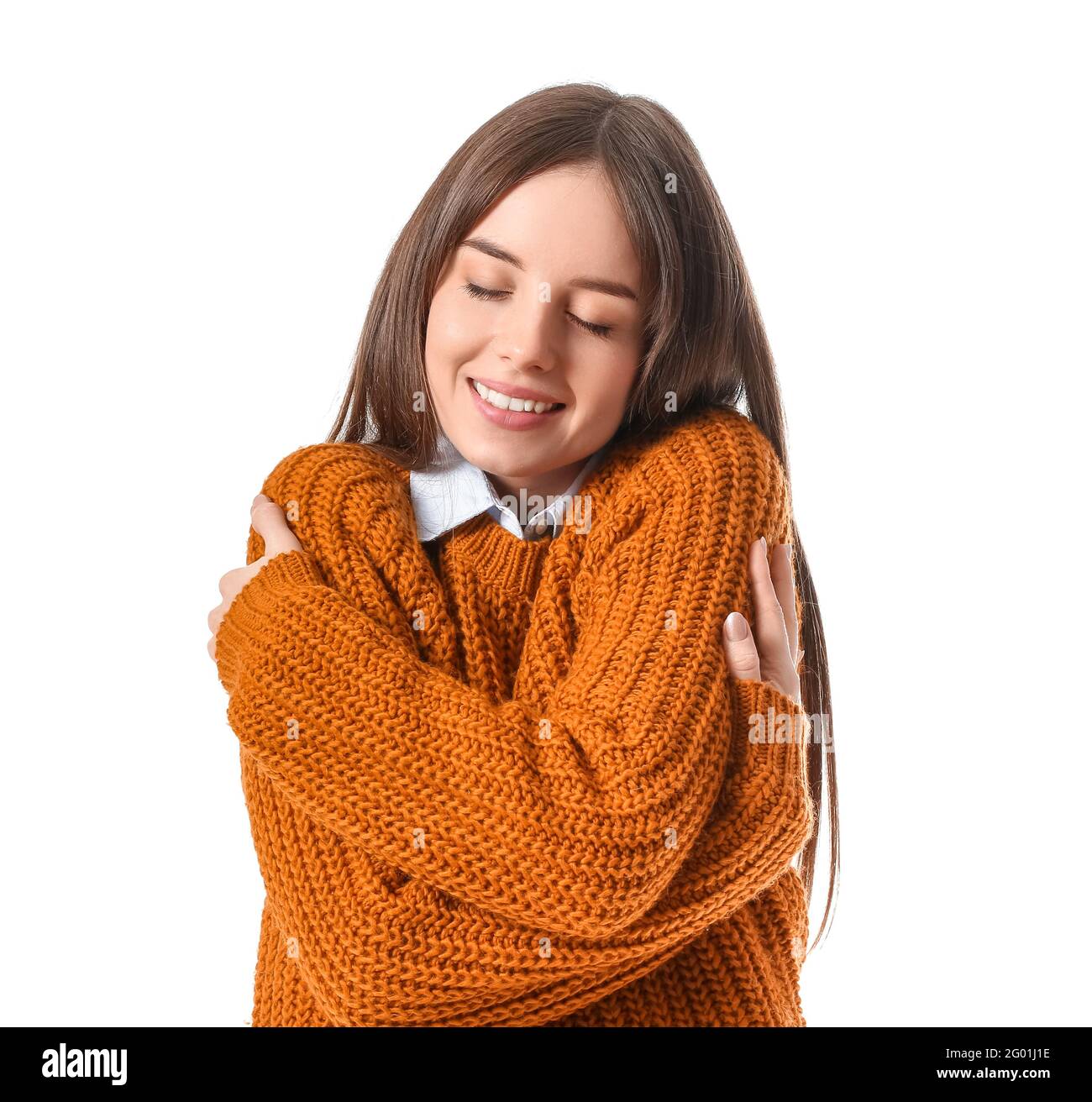 Young woman hugging herself on white background Stock Photo - Alamy