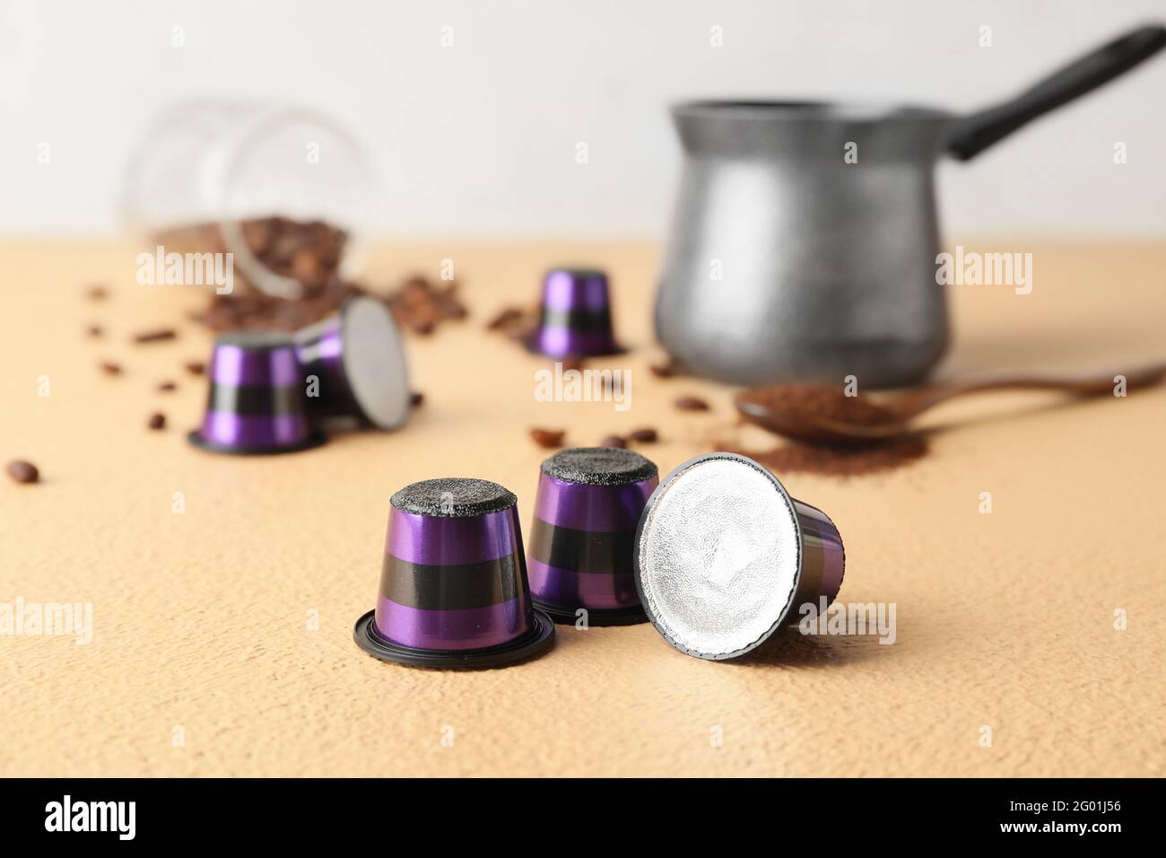 Coffee capsules on color table Stock Photo - Alamy