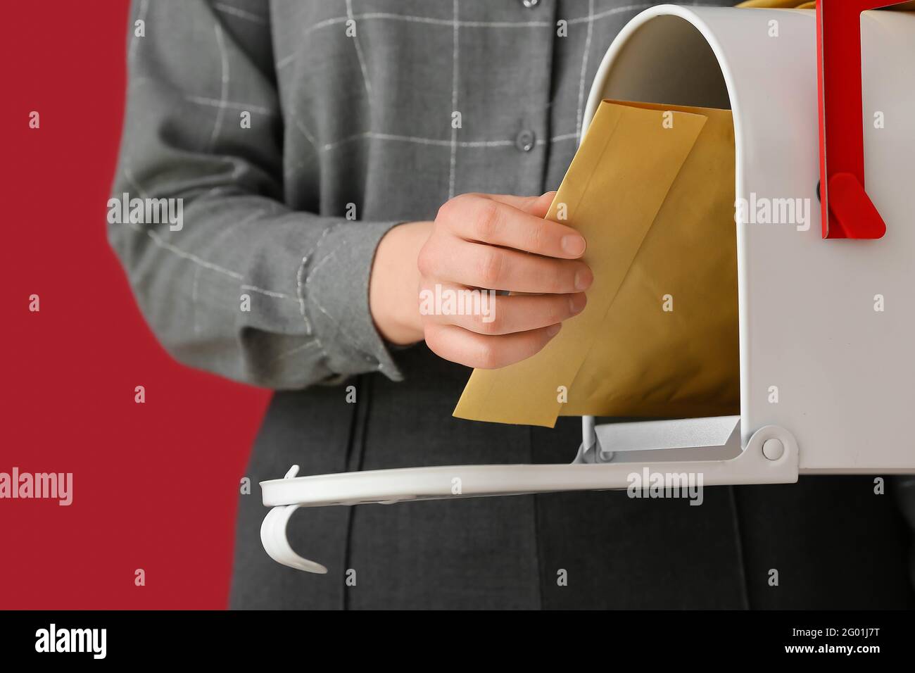 Woman getting letter from box on color background Stock Photo - Alamy