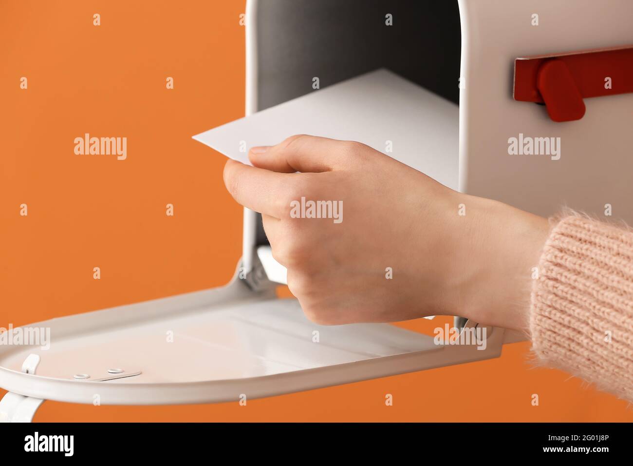 Woman getting letter from box on color background Stock Photo - Alamy