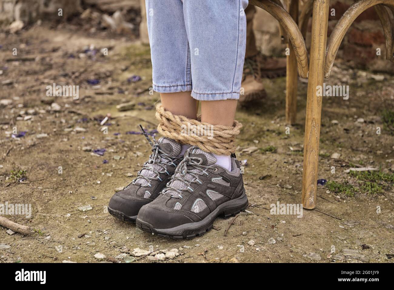 Female hostage sitting on chair outdoors Stock Photo - Alamy