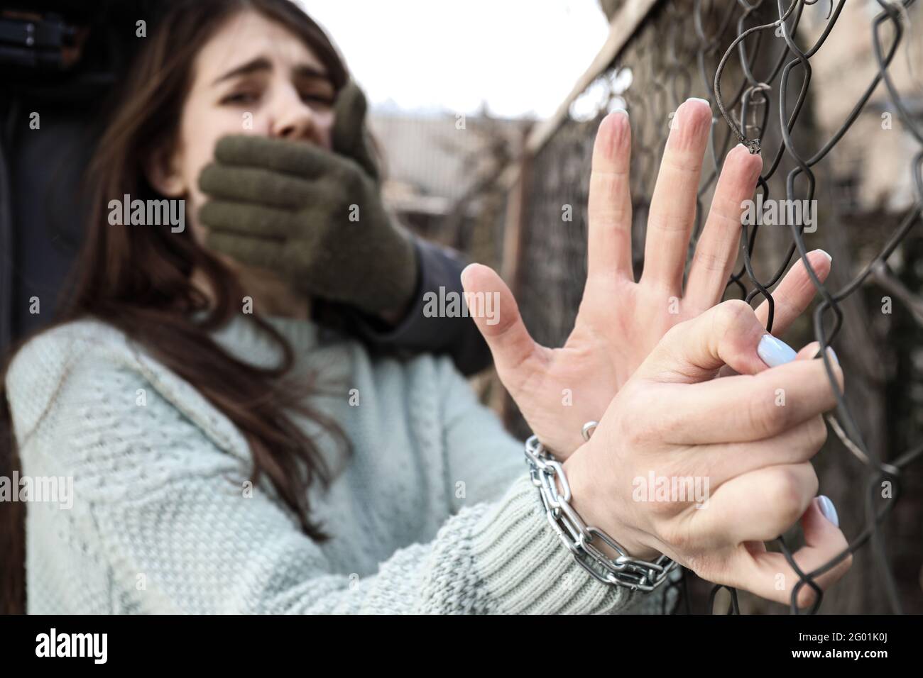 Terrorist with female hostage outdoors Stock Photo - Alamy