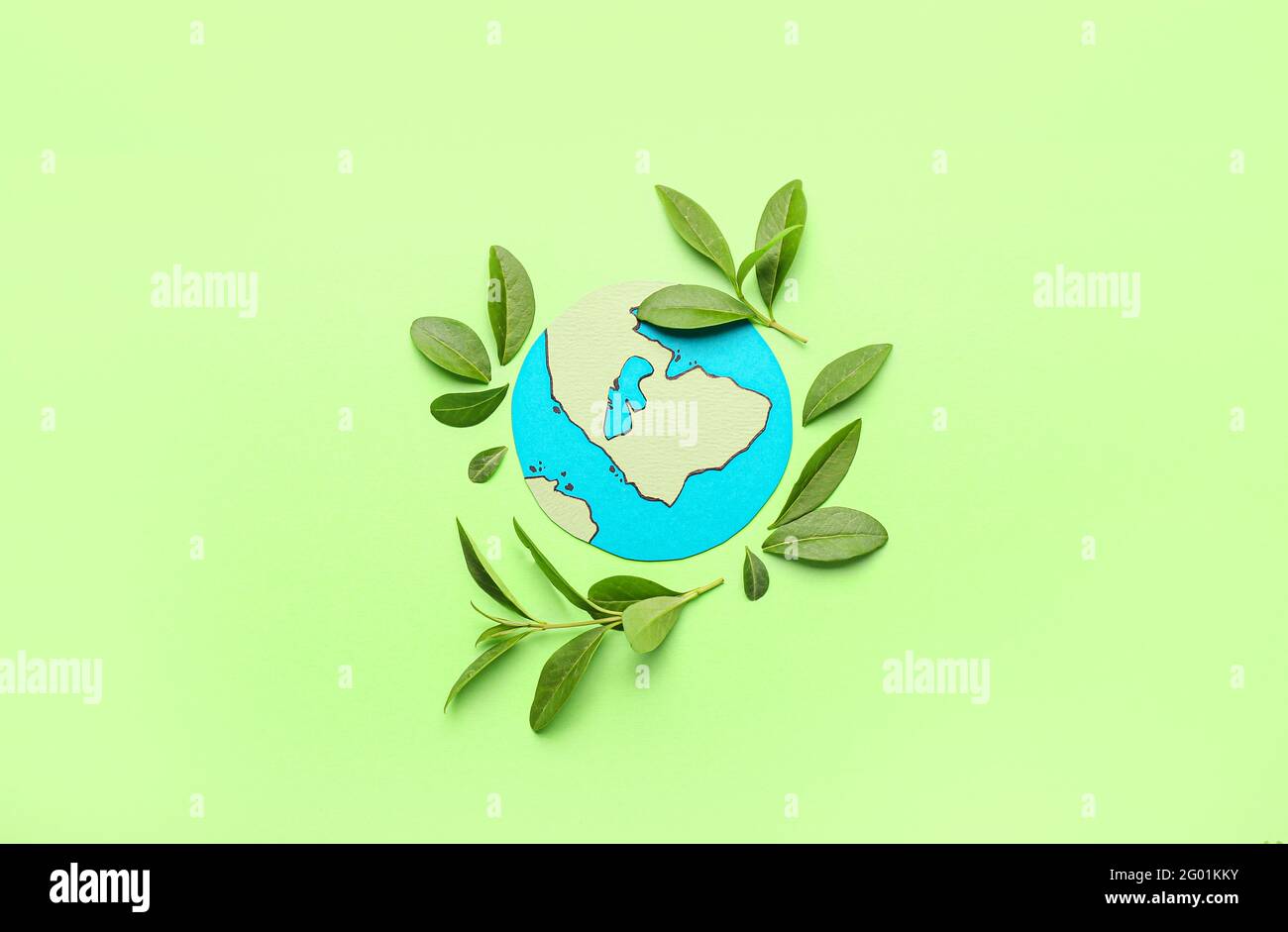 Paper planet Earth with green leaves on color background. Ecology ...