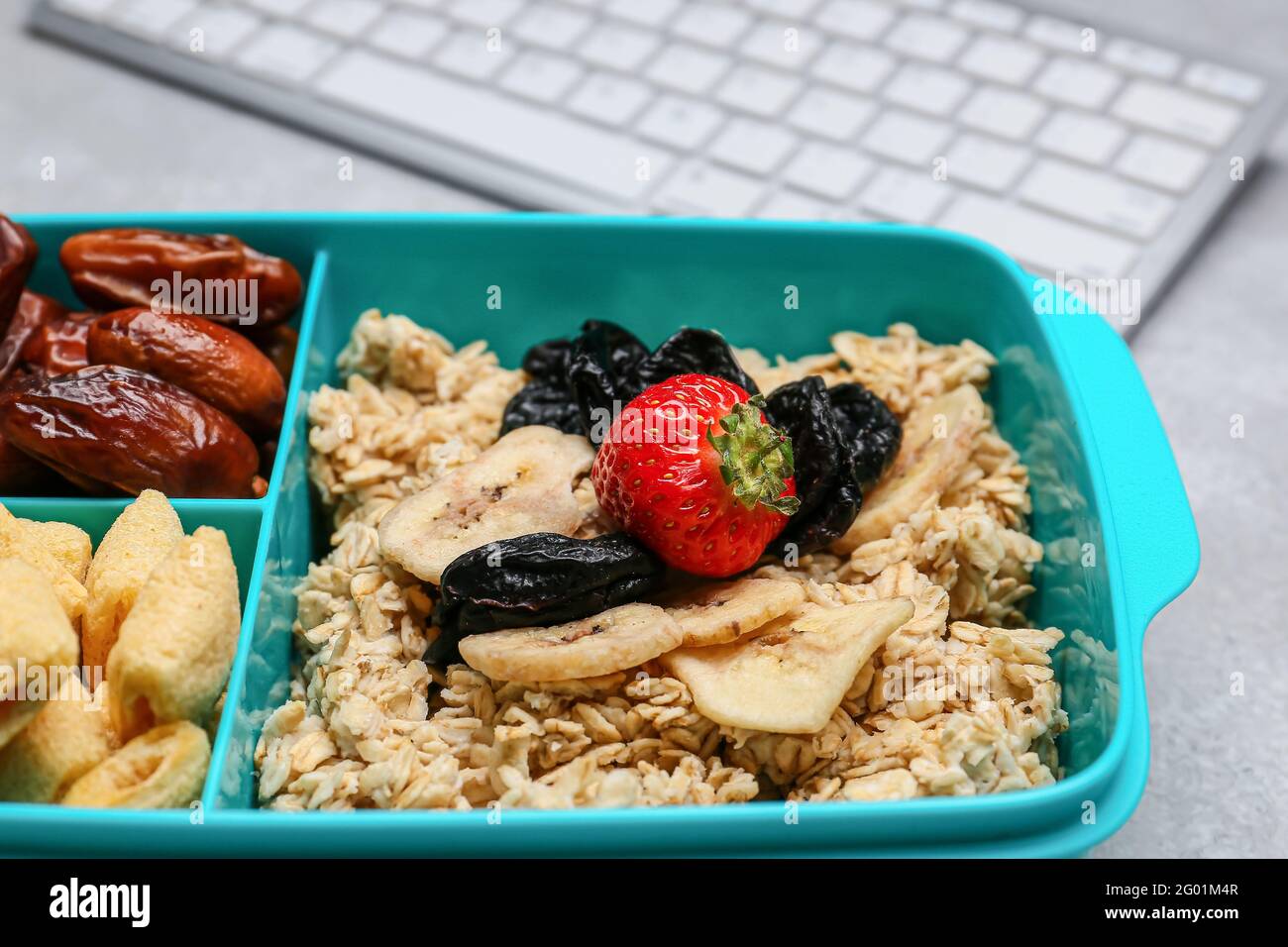 Lunchbox with tasty food and keyboard on light background Stock Photo ...