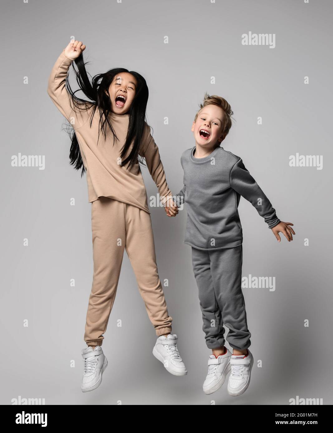 Beautiful girl jumping up together hi-res stock photography and images ...