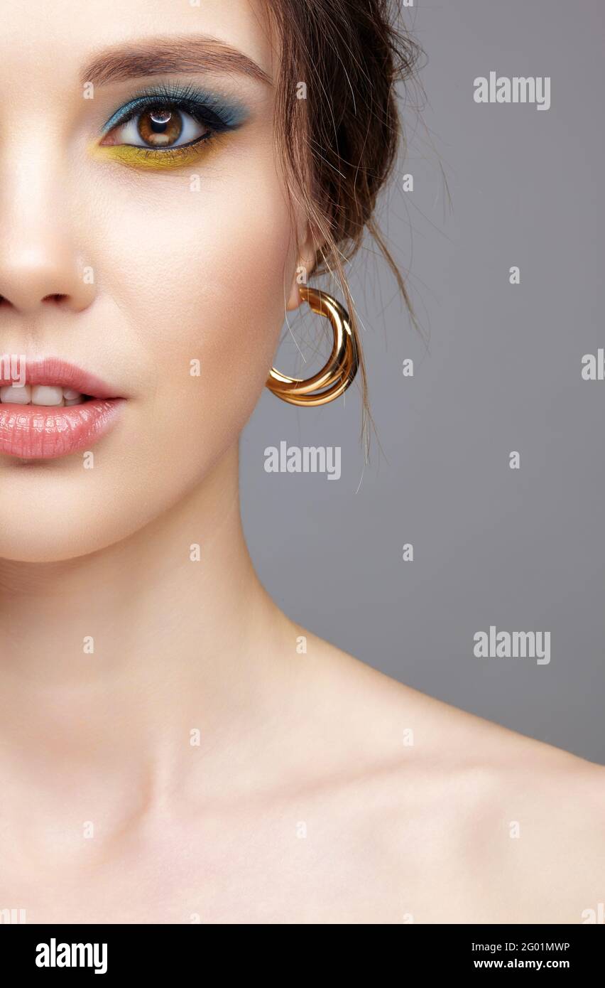 Portrait of young woman on gray background. Female half face. with a ...