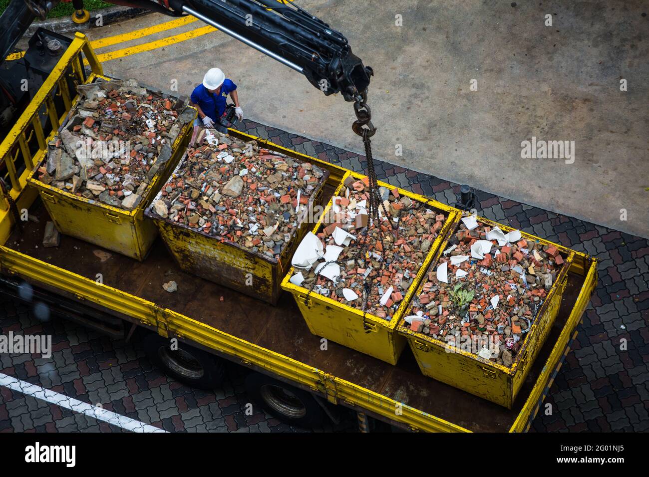 Aerial view of a one man operator to lift the metal container onto the ...
