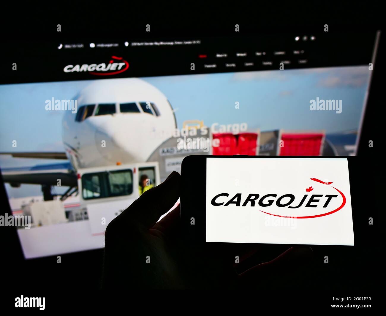 Person holding monbile phone with business logo of Canadian cargo ...