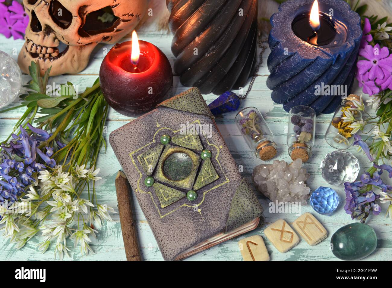 Still life with decorated diary book, runes, crystals and burning ...