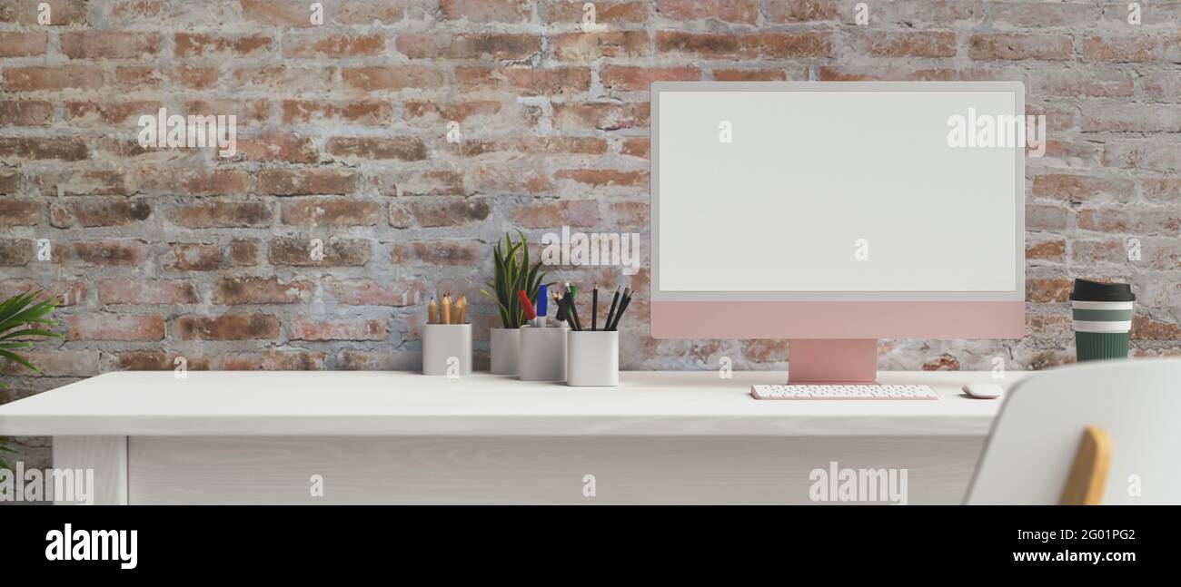 Pink pastel computer monitor with mock-up screen on white table with ...