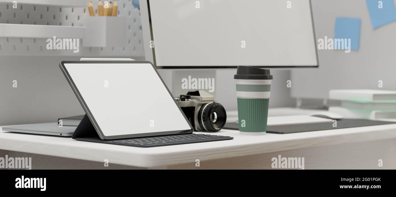 Side view of digital tablet with mock-up screen on computer table in ...