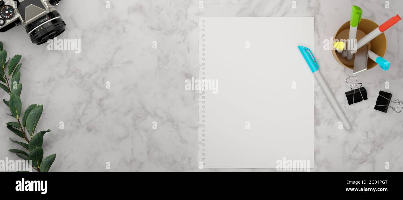 Blank paper, camera and stationery on marble desk decorated with leaves ...