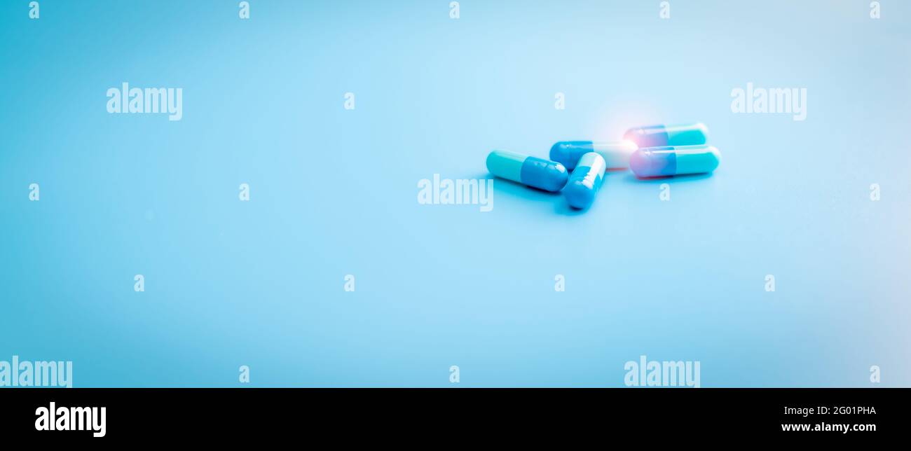 Blue capsule pills on blue background. Pharmacy shop banner ...