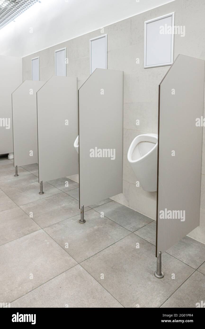 Row of urinal toilet blocks in men public toilet or restroom Stock ...