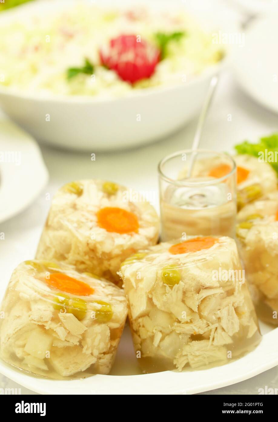 Polish chicken jelly with an out of focus salad on the table Stock ...