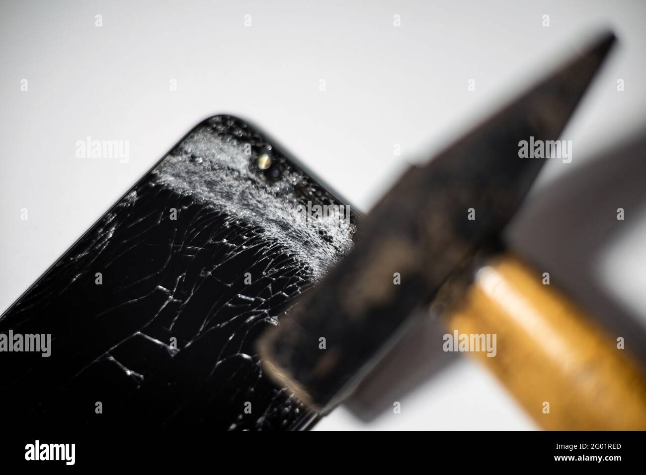 Hammer and smart phone with a broken screen.Electronics repair service ...