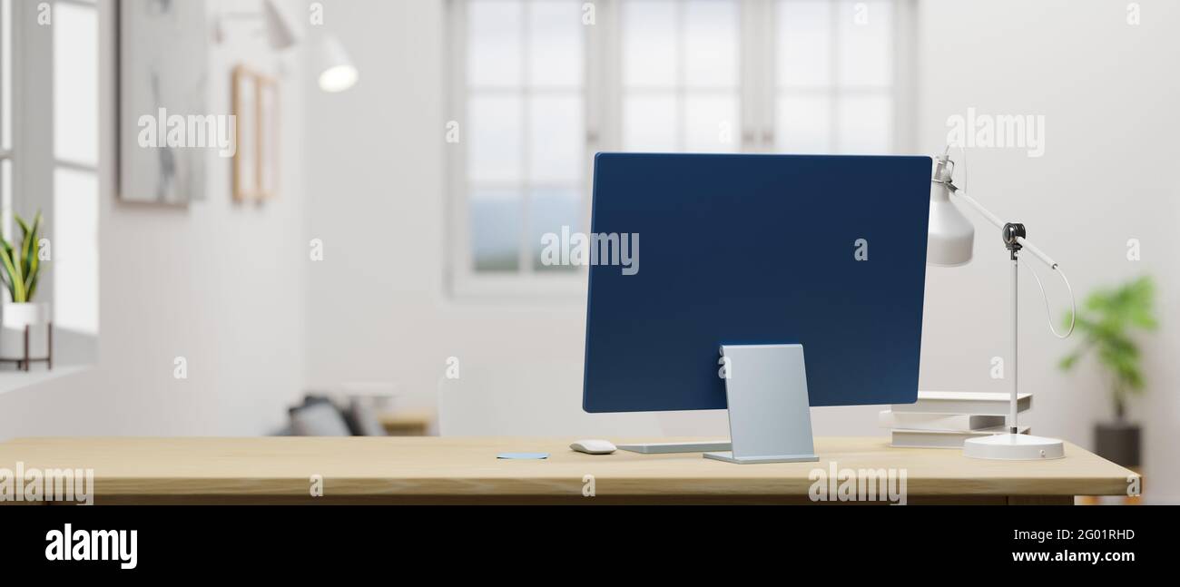 Front view of blue computer monitor on wooden table in office room, 3D ...