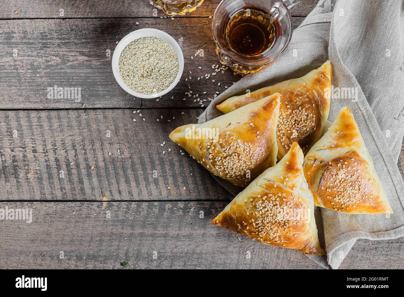 Delicious samosas samsa with meat, glass of tea on wooden table ...