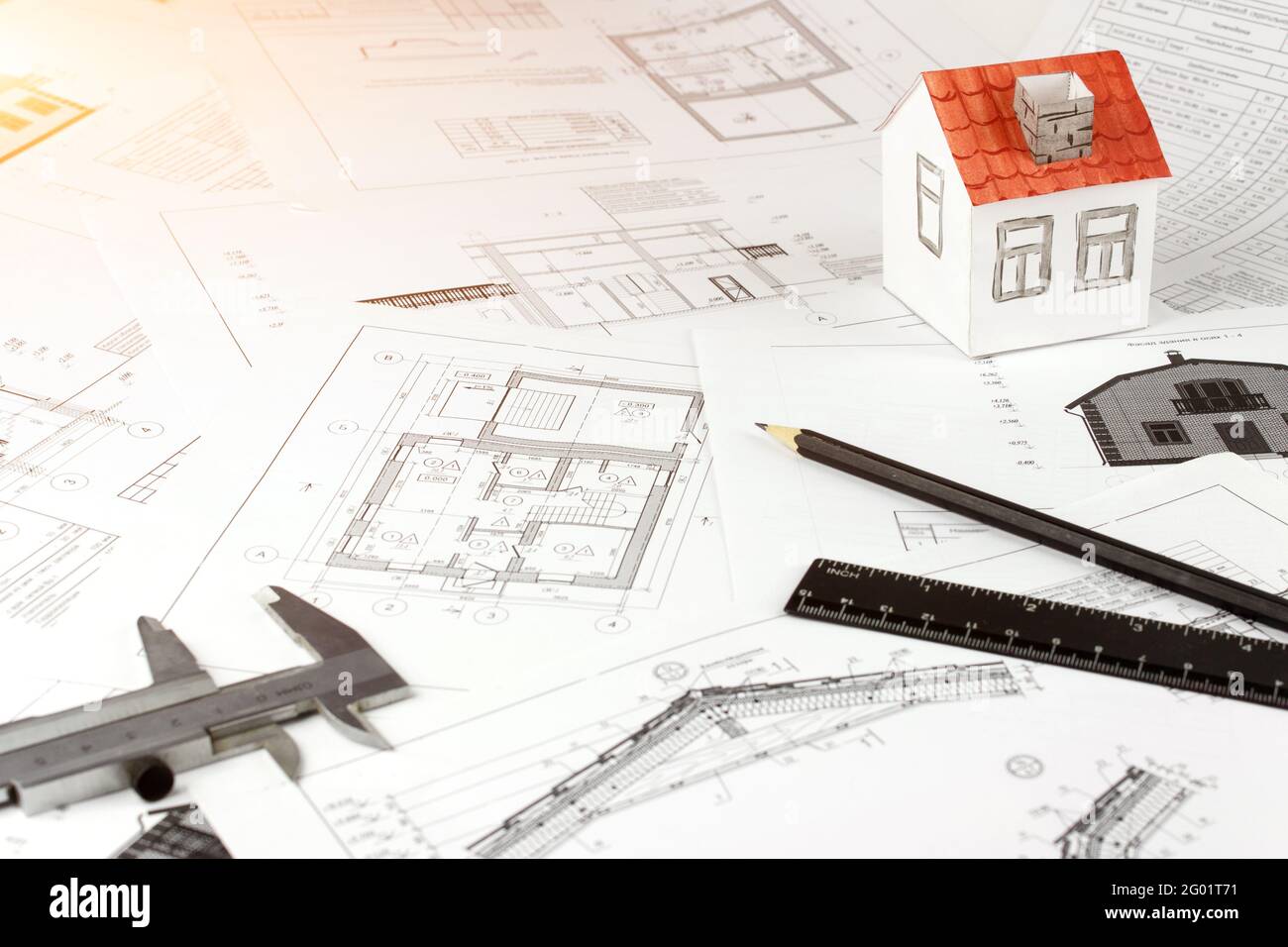 Architectural drawings and small house. Architect's workspace with ...