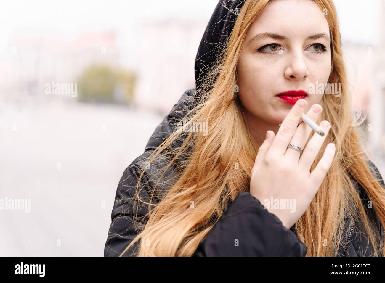 Young woman smoking cigarette red lips hi-res stock photography and ...