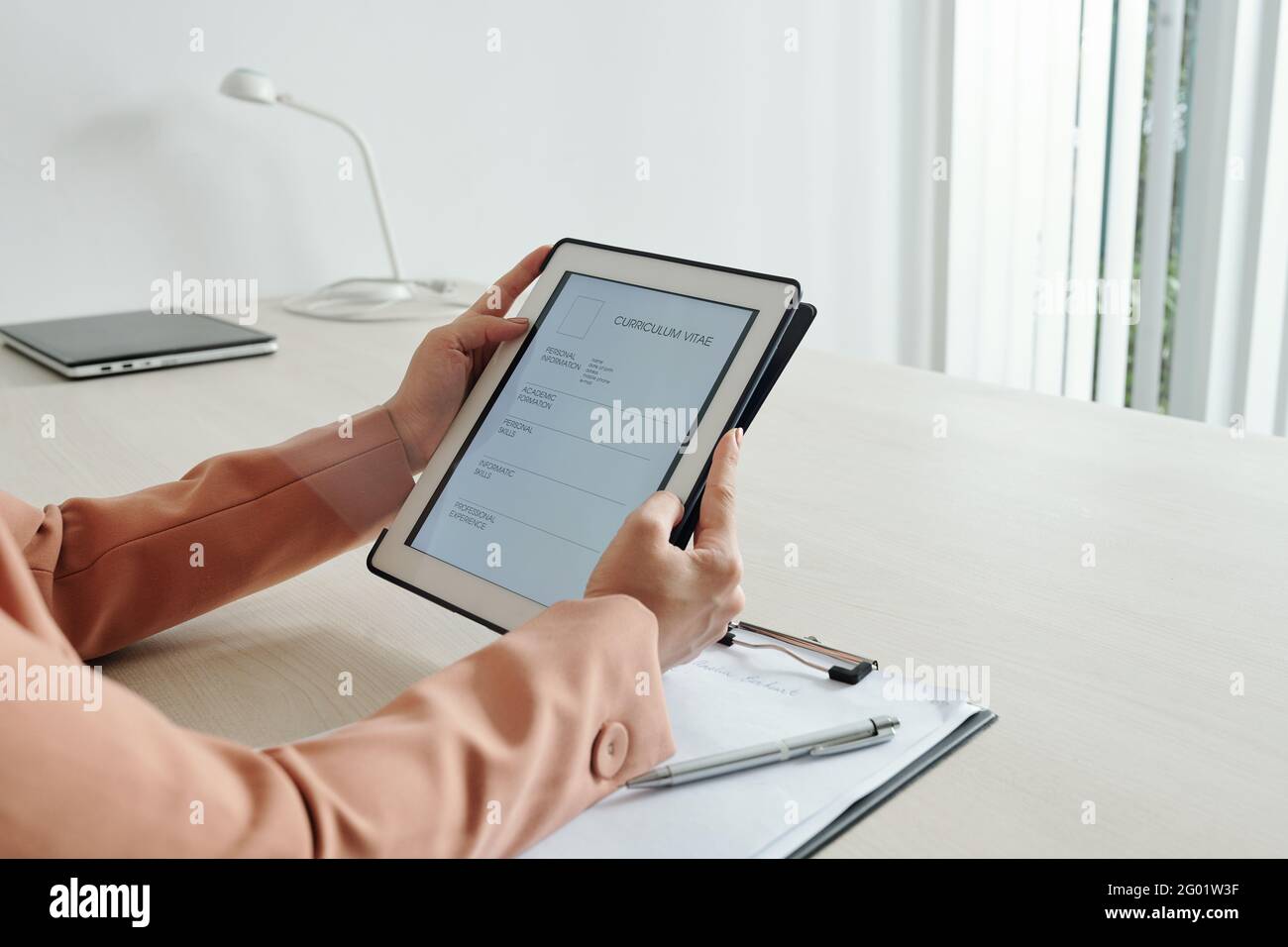 Hands of businesswoman entering personal information in curriculum ...