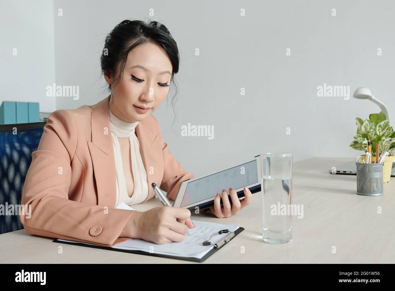 Young businesswoman filling cv form and writing cover letter when ...
