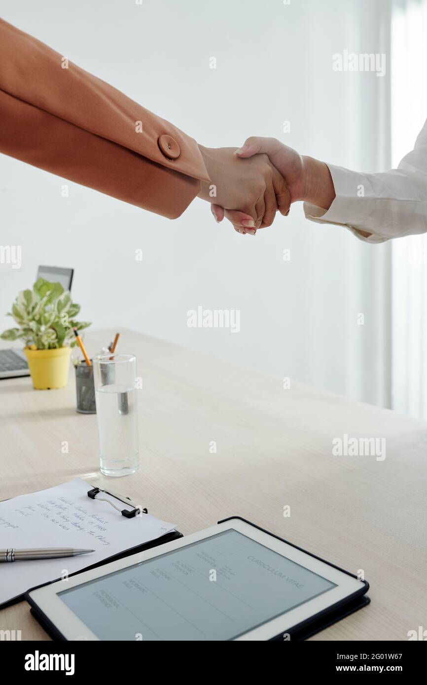 Cropped image of human resources manager and applicant shaking hands ...