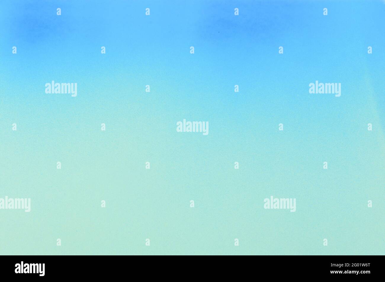 blue spray paint on a soft green colored paper background Stock Photo ...