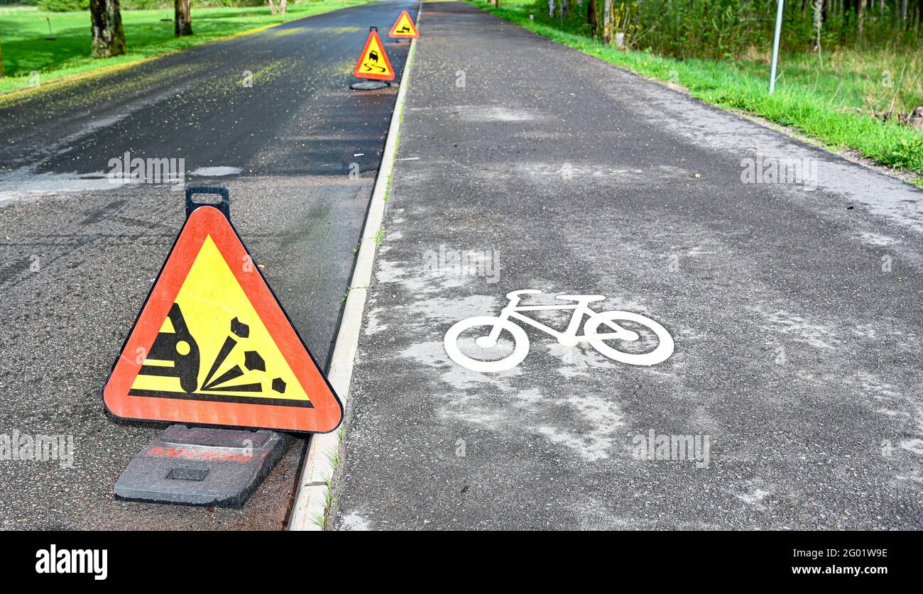 warning signs on road and cycle path Stock Photo - Alamy