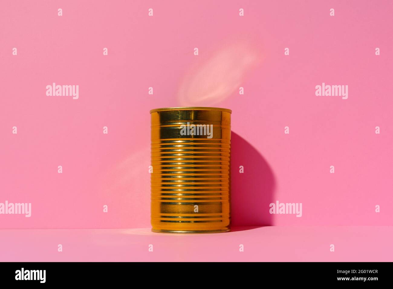 Canned food tin on pink studio background Stock Photo - Alamy