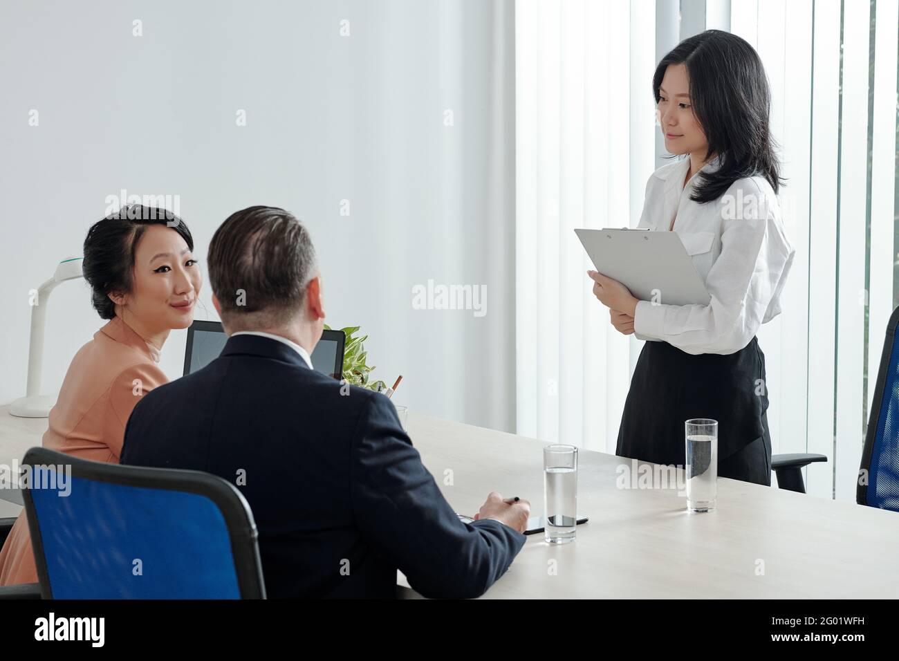 Group of business people gathering in meeting room to discuss problems ...