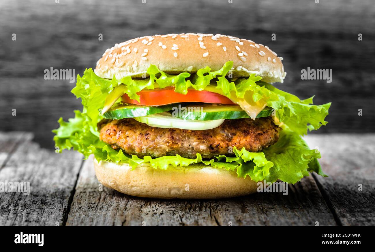 Beef hamburger, close-up, burger bun with grilled meat and vegetables ...