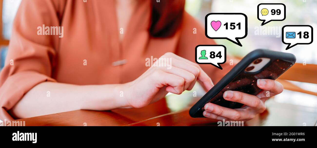 Hands of young woman using smartphone in cafe. Bubbles of social media ...